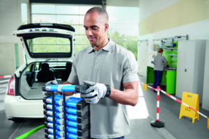Technician replacing battery modules 2 - Professional Motor Factor